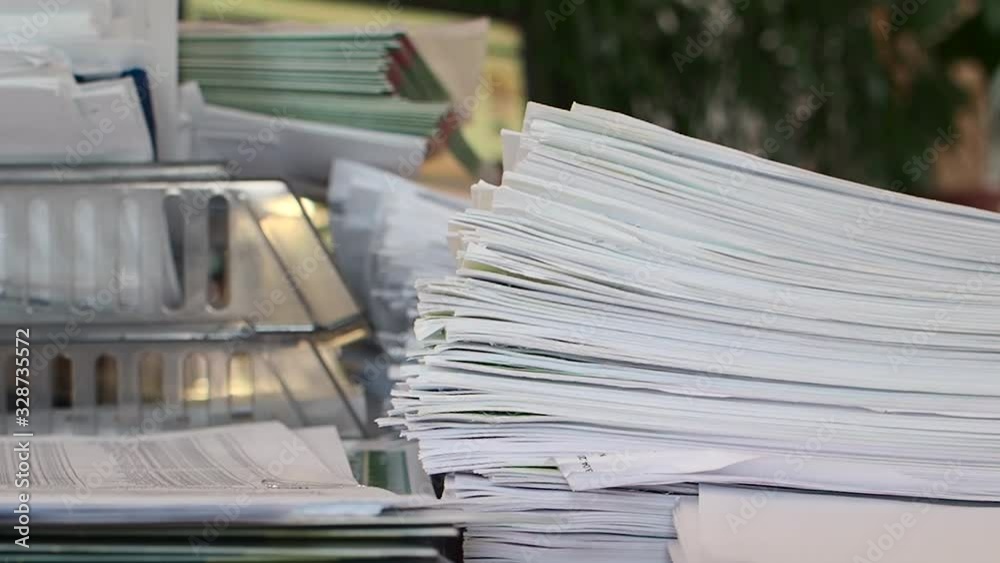 Person putting a stack of sheets on a desk at the office. Stock ビデオ ...