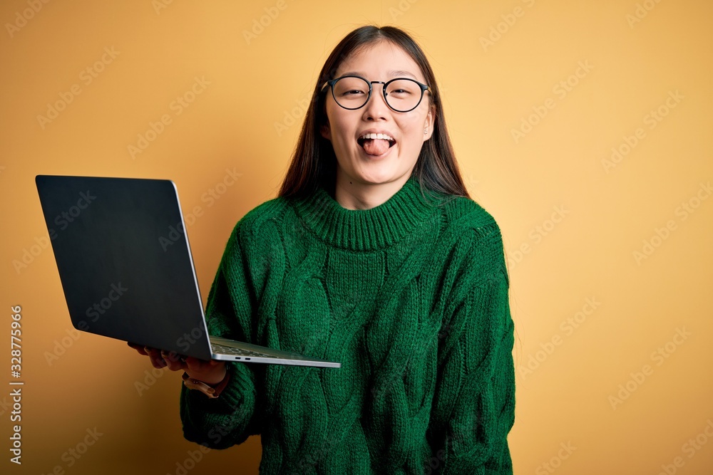 Young asian business woman wearing glasses and working using computer ...