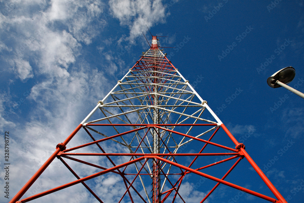 tall metal constructed comunication tower at beautiful blue sky with ...