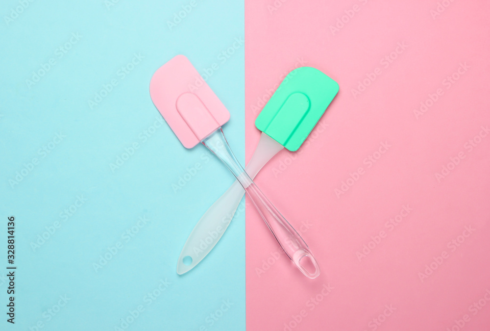 Two kitchen spatula on pink blue pastel background. Minimalism. Top ...
