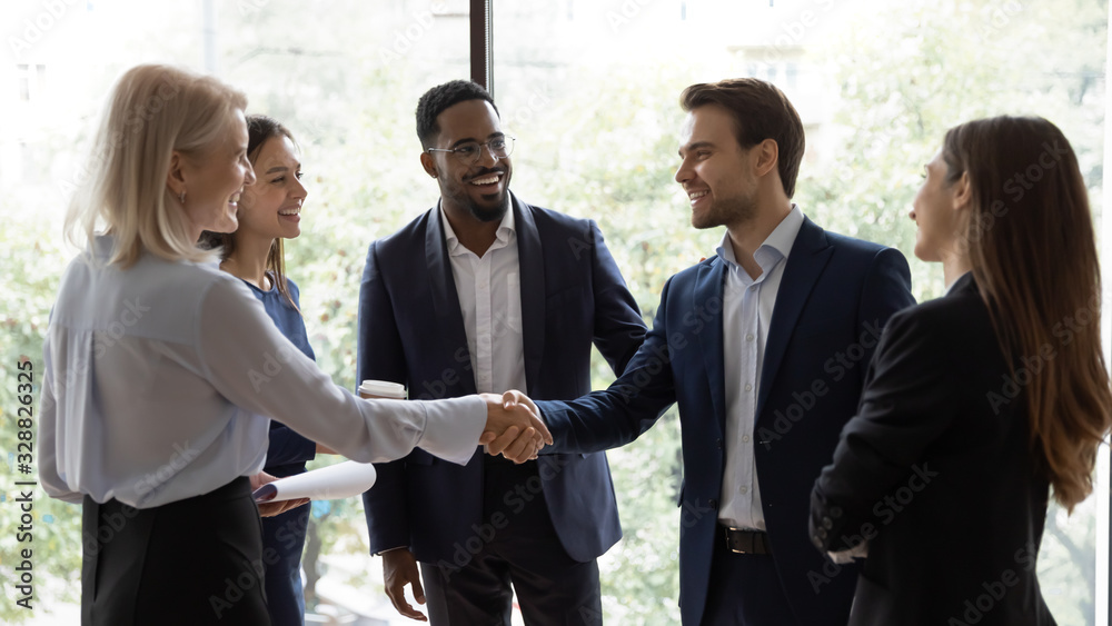 Smiling diverse businesspeople shake hands greeting getting acquainted ...