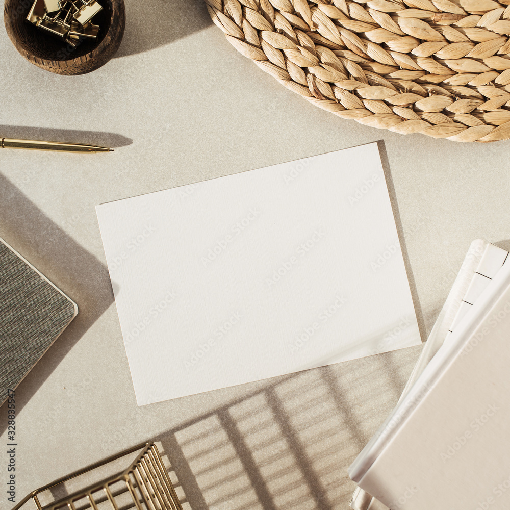 Flatlay blank paper sheet, notebooks, clips in wooden bowl, straw stand ...