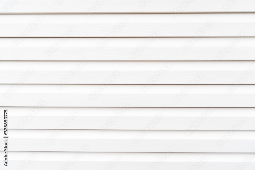 White construction vinyl siding panels. House covered with plastic ...