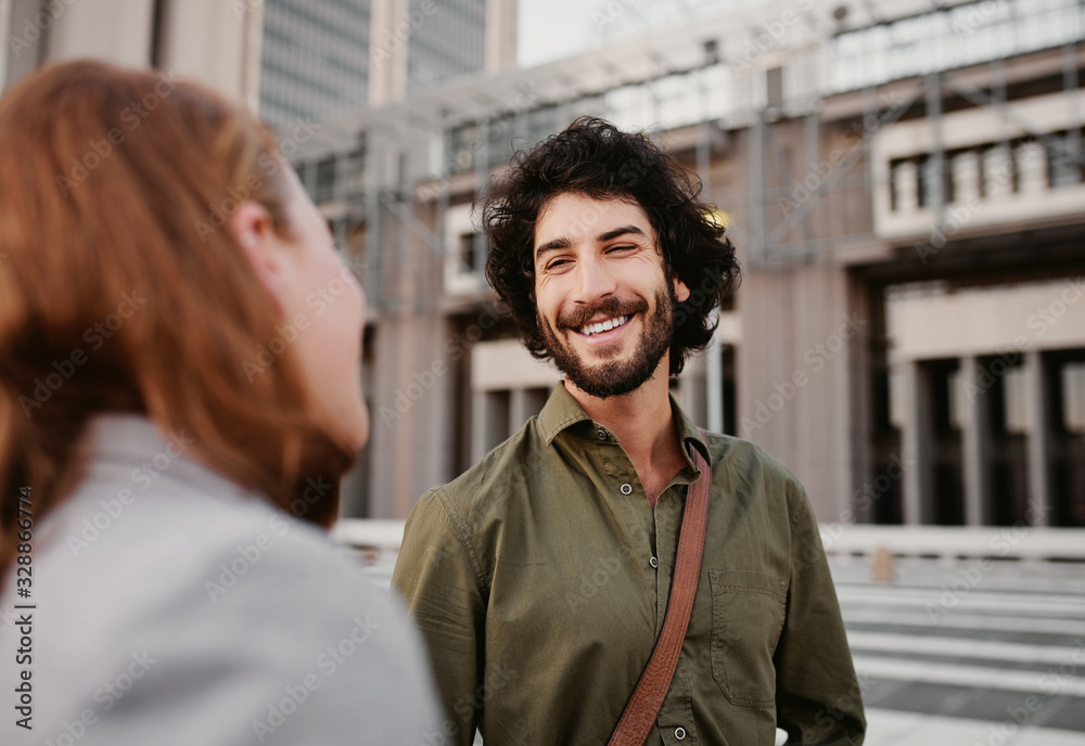 Portrait of successful and laughing business man in conversation with ...