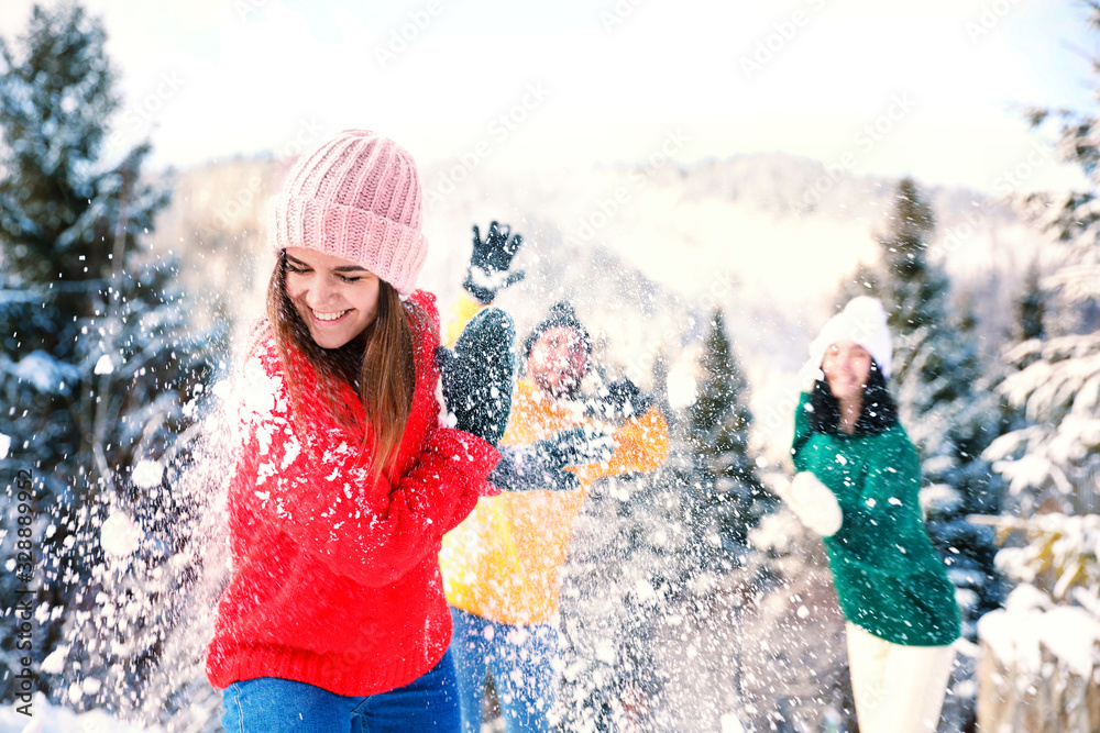 Happy friends playing snowballs outdoors. Winter vacation Stock Photo ...