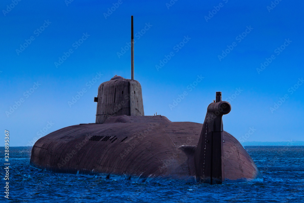 A submarine surfaced above the water. Part of the submarine peeps out ...