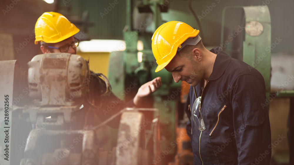 Scene shot of 2 industrial workers feeling upset with the engine ...