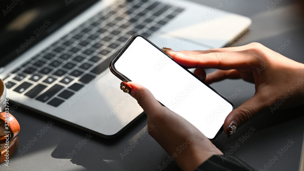 Cropped image of executive woman's hands holding/using a cropped black ...