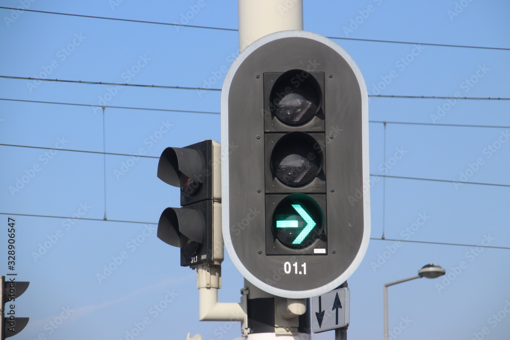 Green traffic light with arrow as indication that cars to left ...