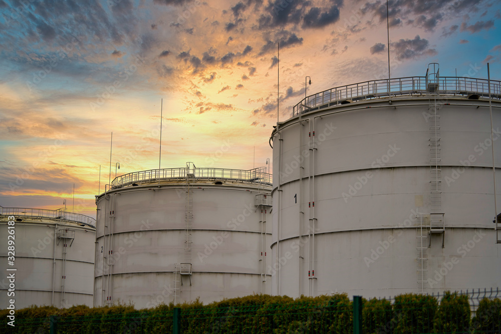 Big industrial oil tanks in a refinery base. Sunset sky Stock Photo ...
