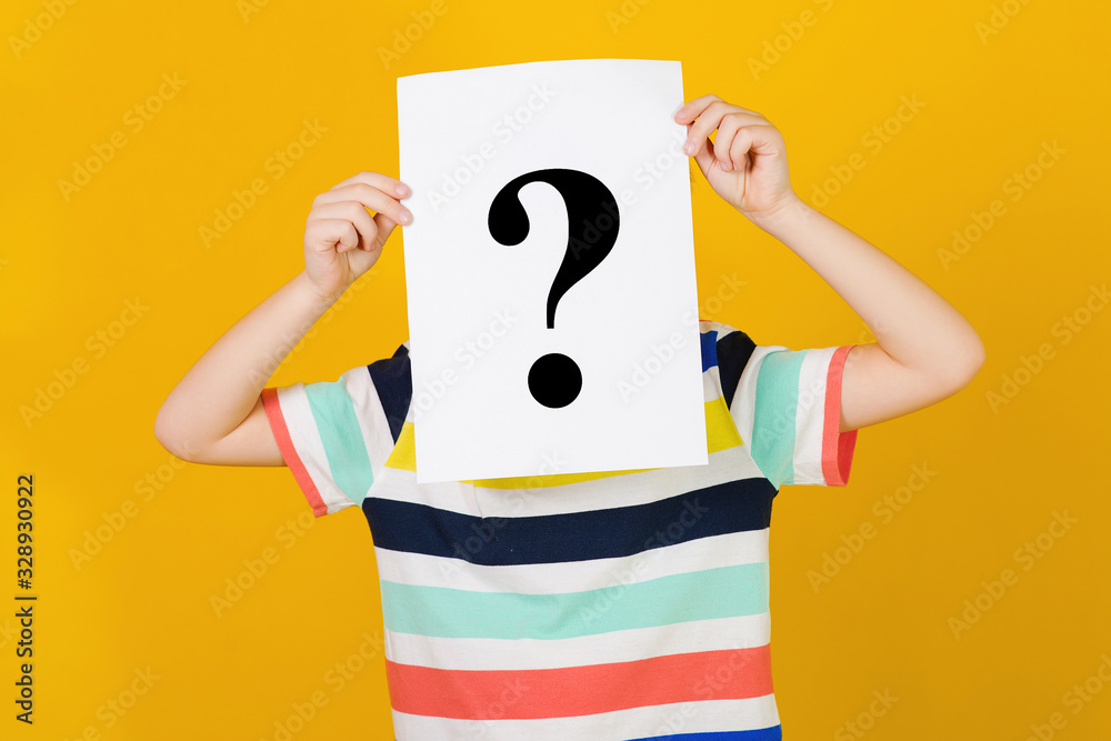 Child covered face with question mark. Schoolboy shows question mark ...