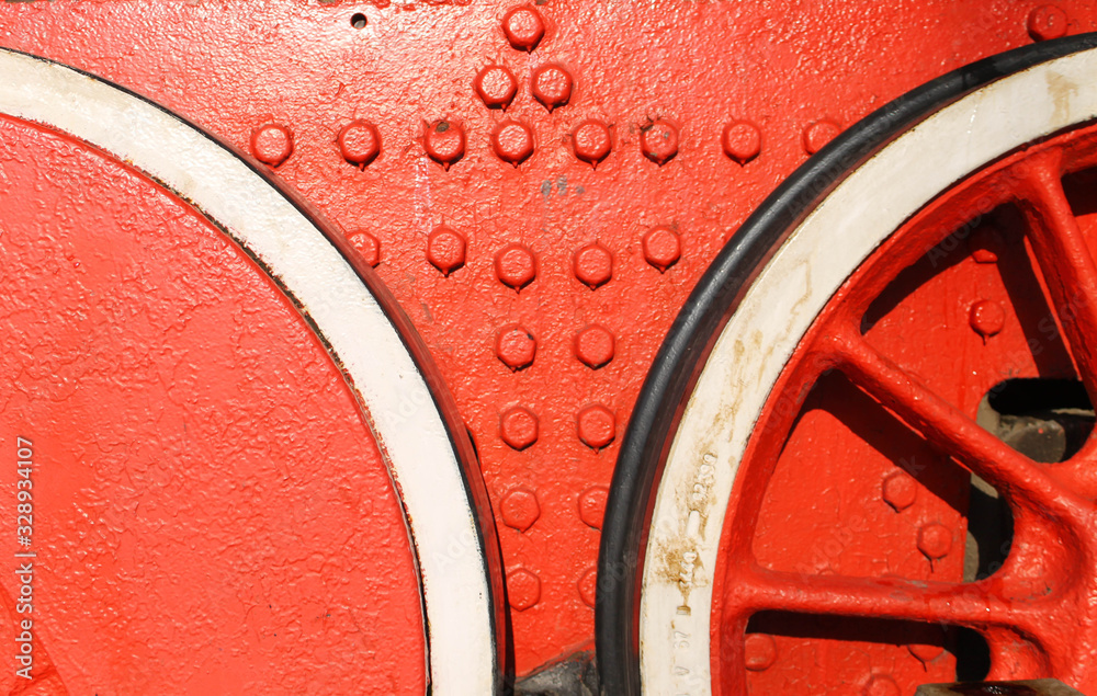 Old steam train wheels. Red background horizontal metal texture with ...