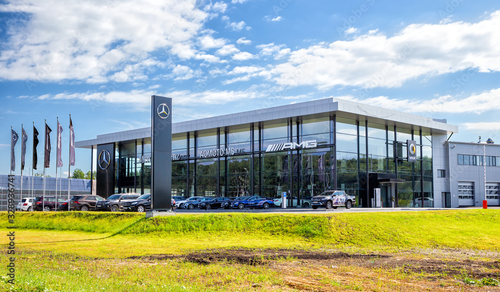 Mercedes-Benz dealership with a modern facade and cars on display in ...