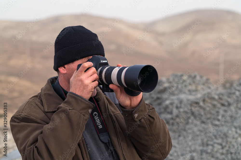 Nature photographer with Canon camera Stock Photo | Adobe Stock