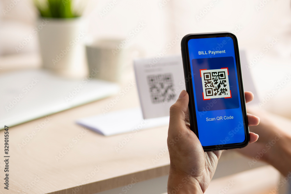 Using Smartphone Scanning QR Code for bill payment option Stock Photo ...
