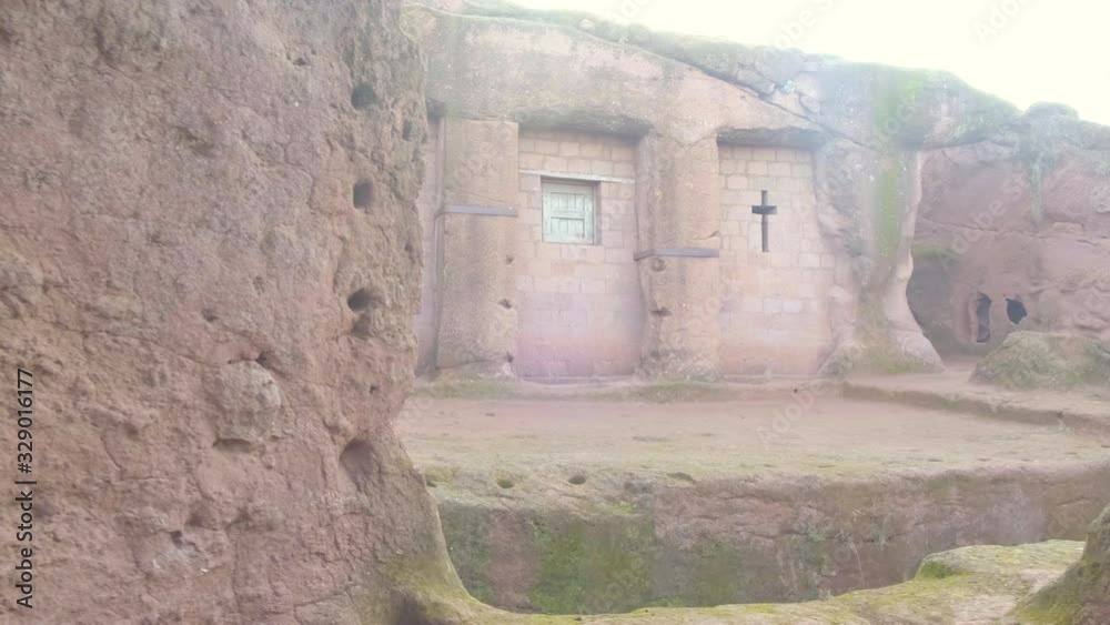 Camera track right from behind wall to reveal front facade of Bet ...