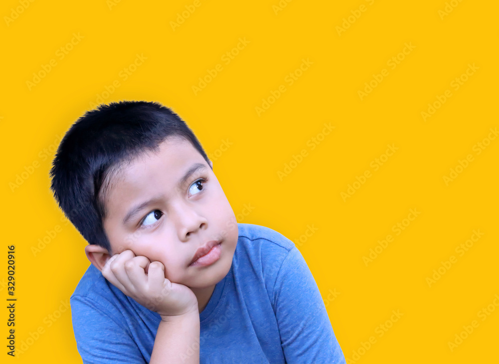 Portrait of cute boy thinking with hand on chin isolated on white ...