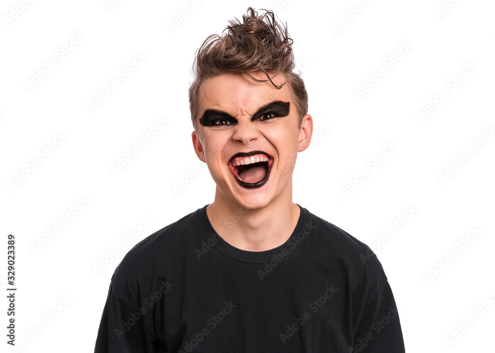 Rebellious teen boy dressed in black, isolated on white background ...