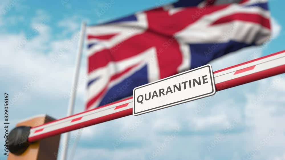 Barrier gate with QUARANTINE sign being closed with flag of the UK as a ...