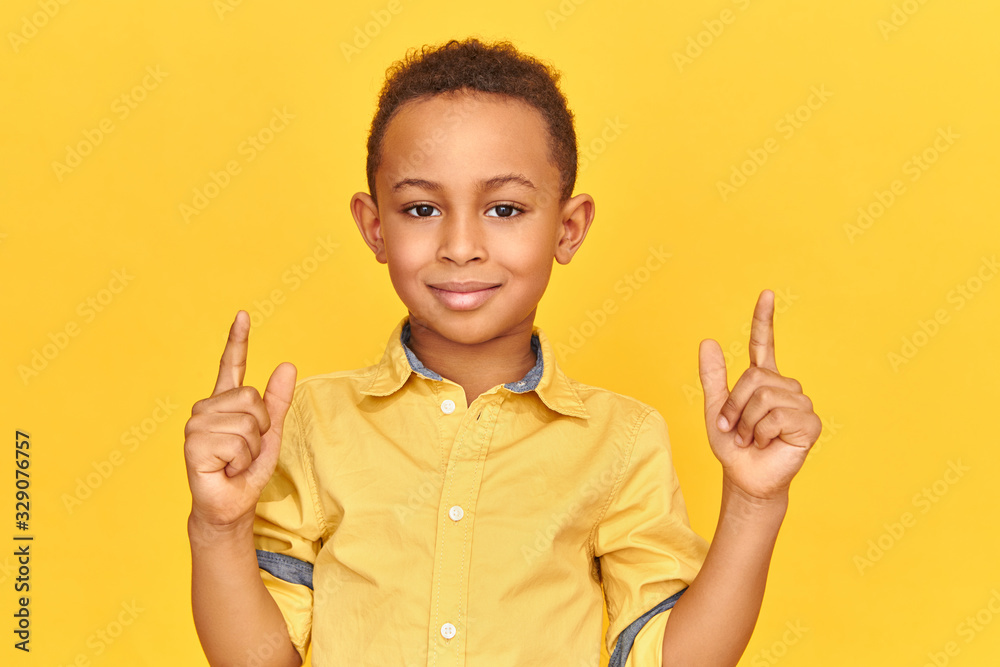 Handsome joyful Afro American boy having happy facial expression ...
