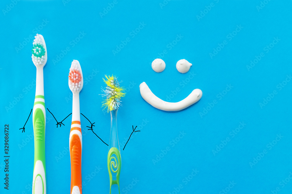 New and old toothbrushes in the form of cartoon characters on a blue ...