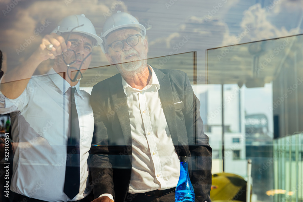 Two industrial engineer wear safety helmet engineering working and ...