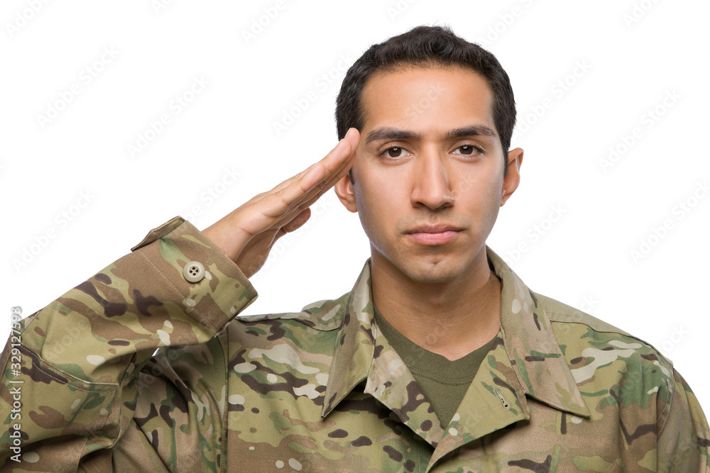 Army soldier saluting while looking serious at the camera on a white ...