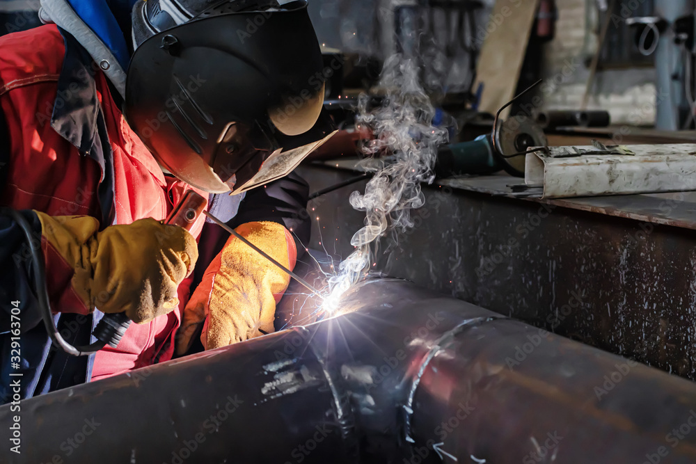 Applying a facing weld using manual arc welding Stock Photo | Adobe Stock