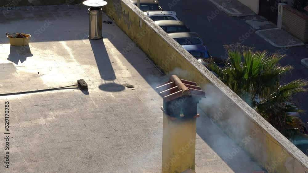 Toxic smoke coming from the chimney pipe on the house roof. Heavy ...