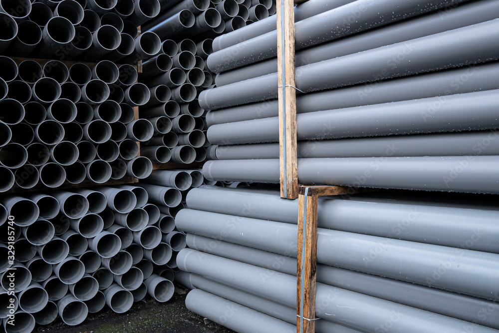 Gray PVC tubes plastic pipes stacked in rows Stock Photo | Adobe Stock