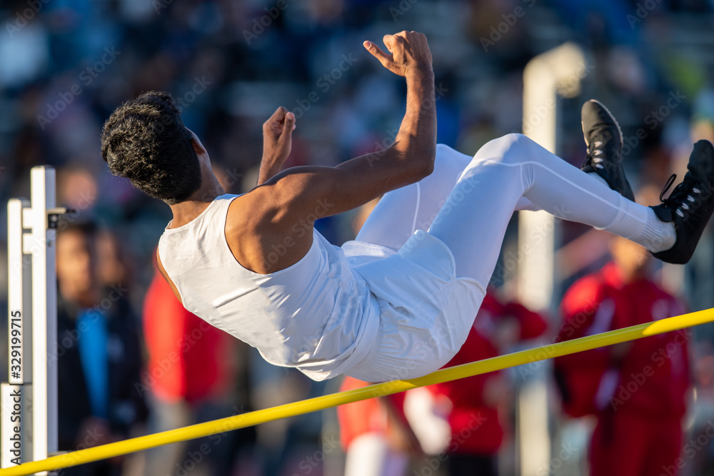 Young boy competing in the high jump at a track meet Stock Photo ...