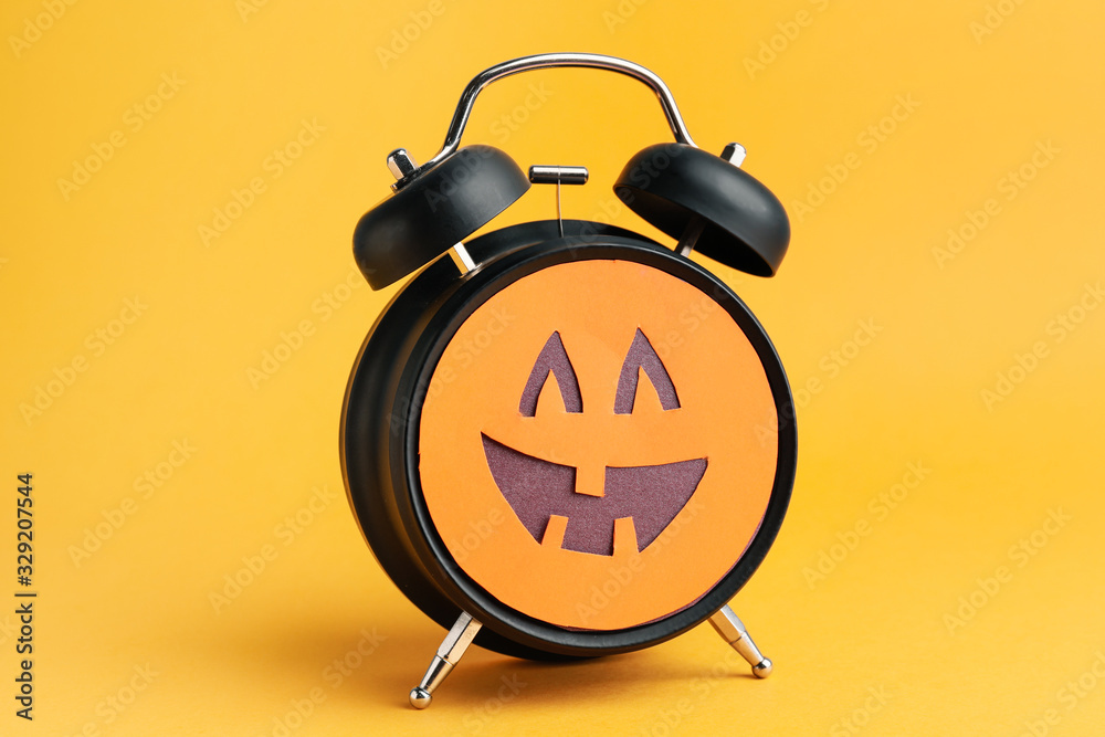 Alarm clock with scary face on color background. Halloween celebration ...