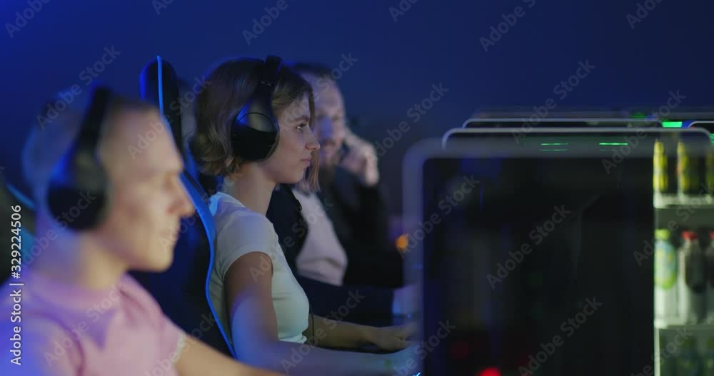 Girl is passionate about playing in a computer club, a team game with ...