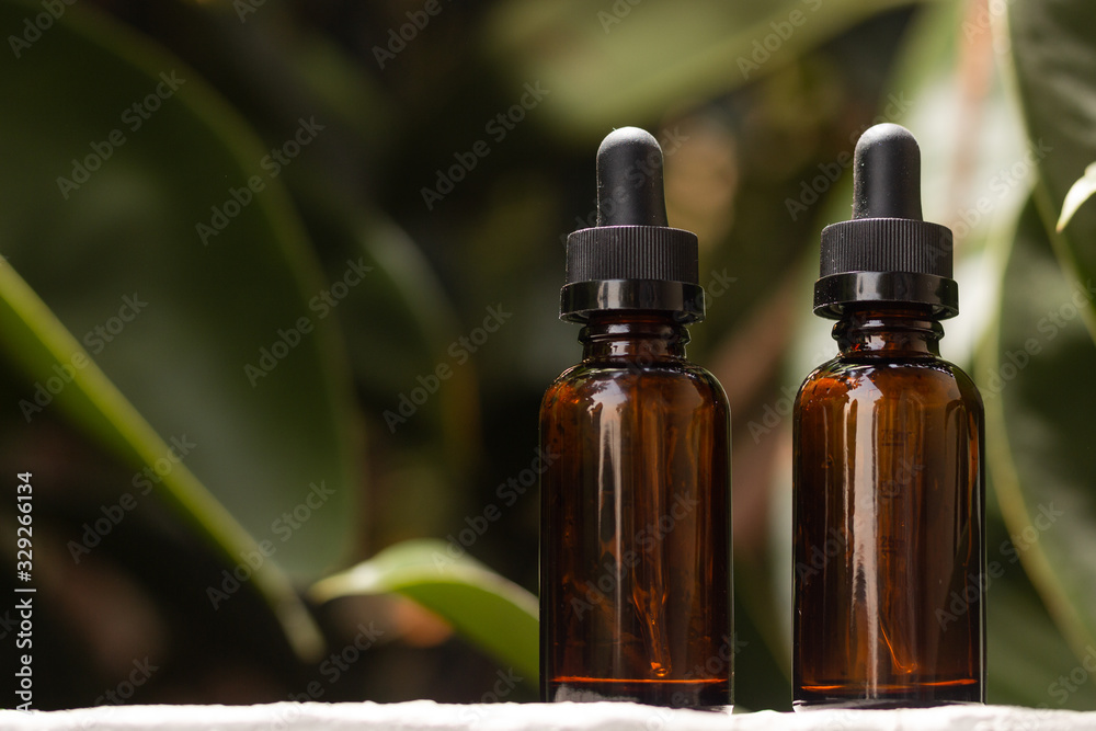 Pair of empty droppers in the foreground in front of nature background ...