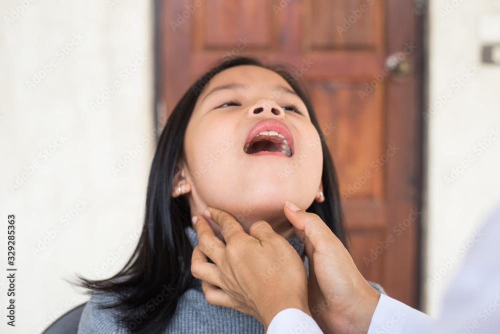Child with doctor. pediatrician probing touching lymph nodes on neck of ...