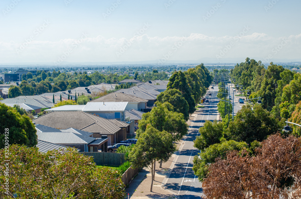 Aerial view of residential houses by a main road in Melbourne's suburb ...