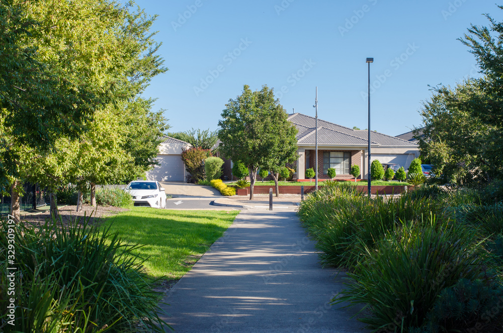 Poster A pedestrian footpath/walkway leads to residential houses in an ...