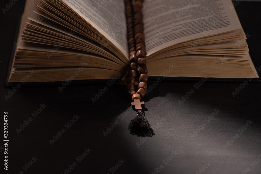 holy bible with rosary on black dark background with sunlight Stock ...