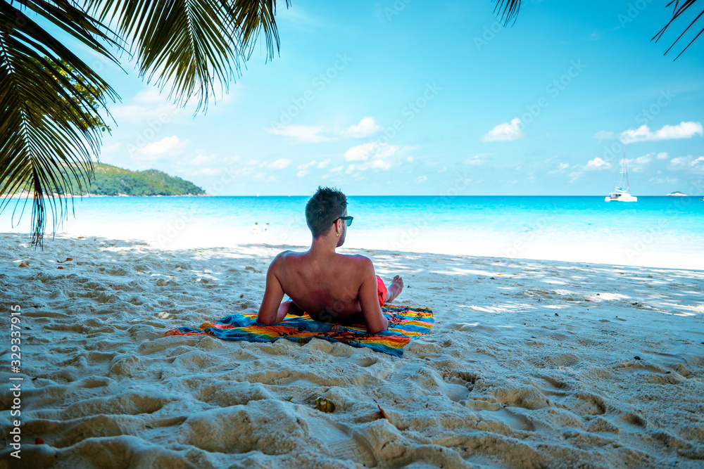 Praslin Seychelles,young men on tropical beach with palm tree, white ...