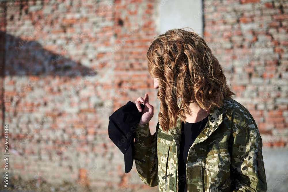 Young curly blond military woman, wearing ukrainian military uniform ...