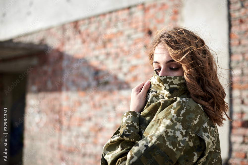Young curly blond military woman, wearing ukrainian military uniform ...