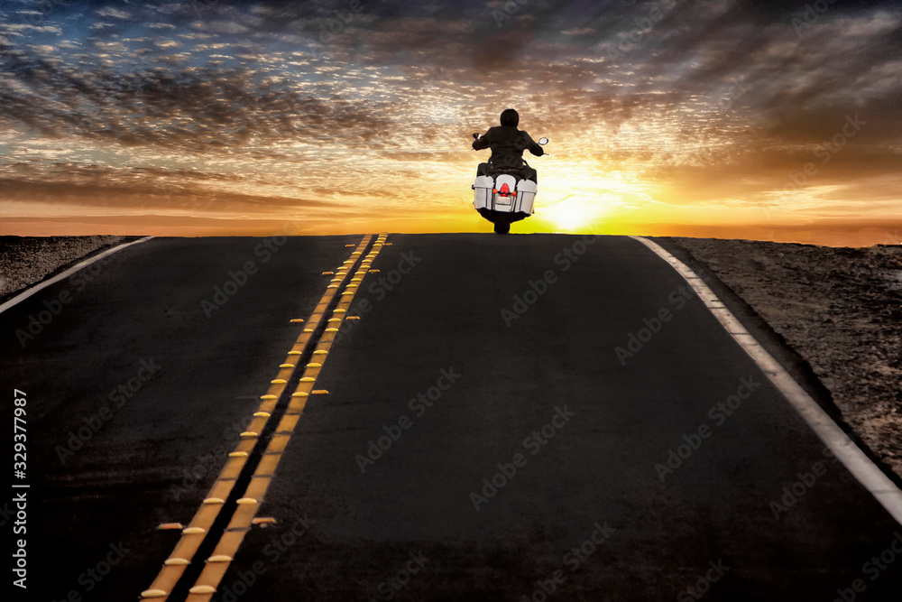 Motorcycle rider on street riding toward sunset sky Stock-Foto | Adobe ...