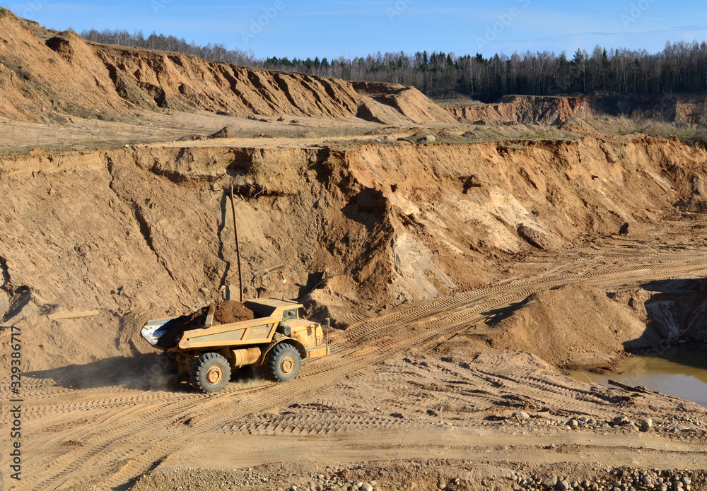 Big mining truck transportion sand in the open-pit. Heavy machinery in ...