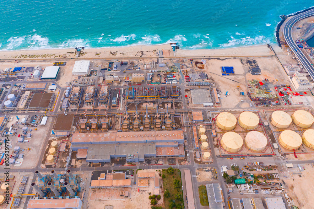 Aerial view of petrochemical oil refinery and sea in industrial ...