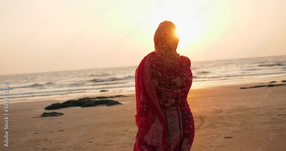 Young women wearing a red saree on the beach goa India.girl in ...