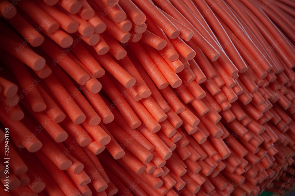 Abstract background of paralon tubes. Texture of red paralon cylinders ...