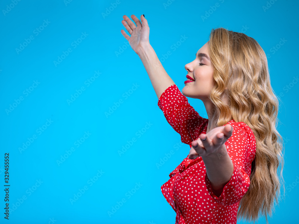 Young happy blonde woman with raised hands. Beautiful girl with raised ...