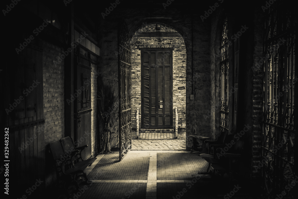 Drawing-like view of scary passage leading to an old brick arch with a ...