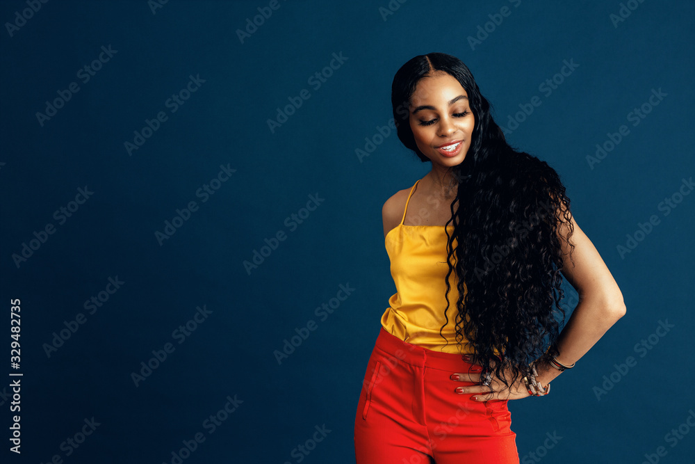 Portrait of a happy young woman with very long beautiful black curly ...