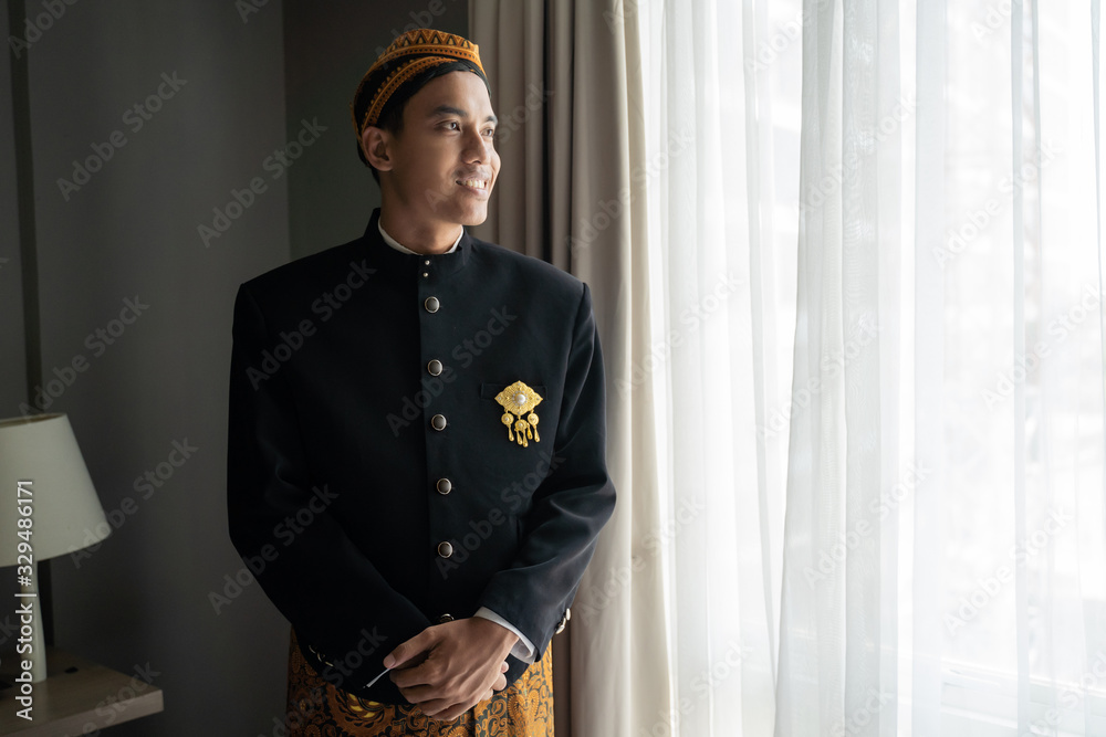 Young asian man wearing traditional clothes,beskap is traditional ...